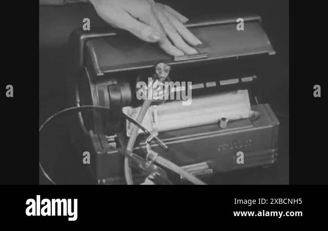 Office workers, damaged typewriters and a serviceman repairing a ...