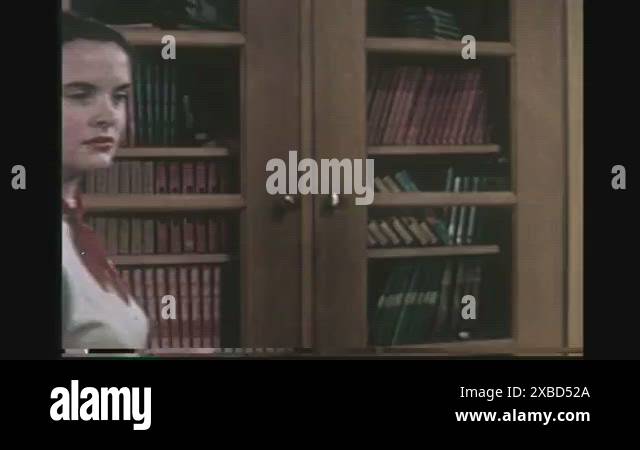 A growing suburban city is built around a schoolhouse in the 1950s and ...