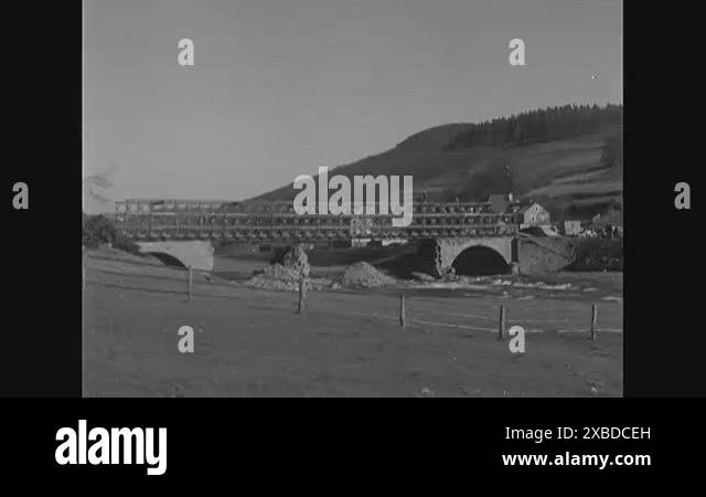 GERMANY - 1945 - US 2 1/2 ton truck crosses a bridge over Eden River ...
