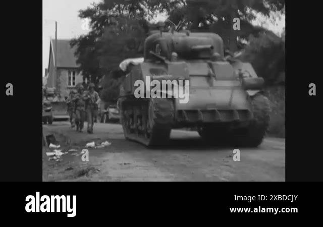 NORMANDY - 1944 - WW2 soldiers enter towns, search prisoners, and pass ...