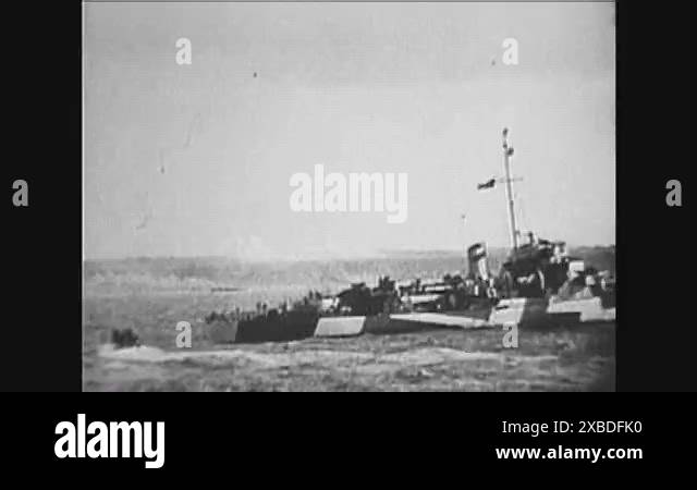 Airplanes and battleships fire and troops boat in to the beaches of ...