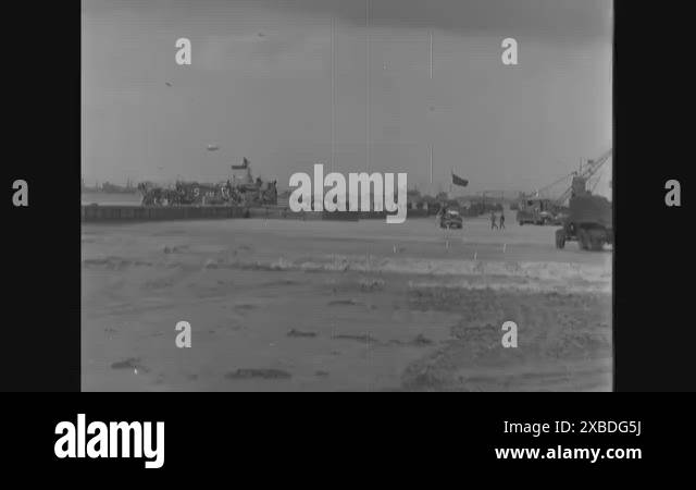 NORMANDY - 1944 - American replacement troops march along the causeway ...