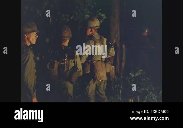 1966 - American soldiers trek through a Vietnamese jungle from night ...