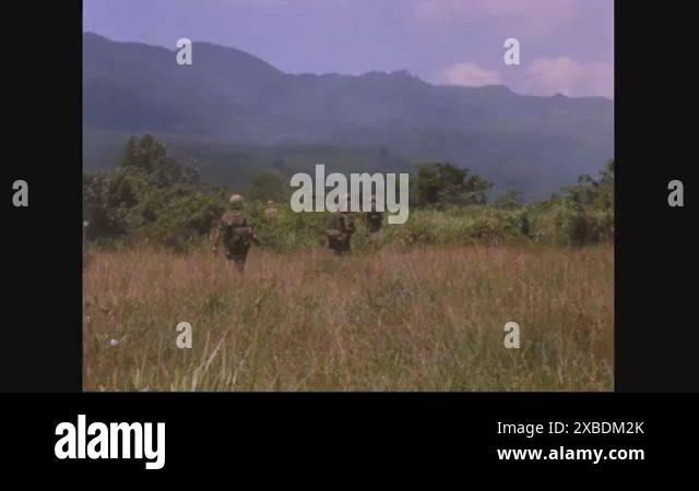1967 - A US Army mortar squad walks through underbrush in Chu Lai ...