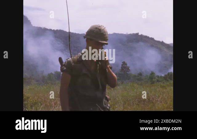 1967 - The leader of a US Army rifle squad throws a smoke grenade in ...