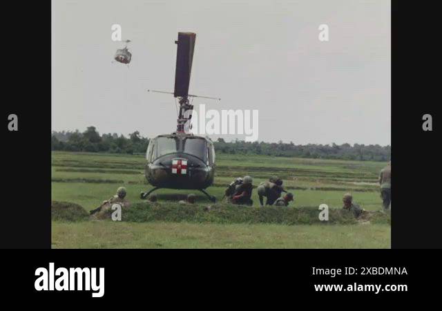 1960s, Vietnam War, medical helicopters land in a field and pick up a ...