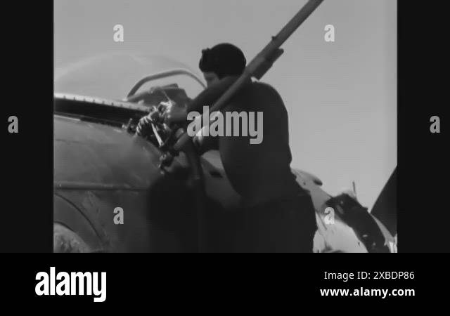 KOREA - 1953 - A sailor adds fuel to the wing tip tank of a Grumman F9F ...