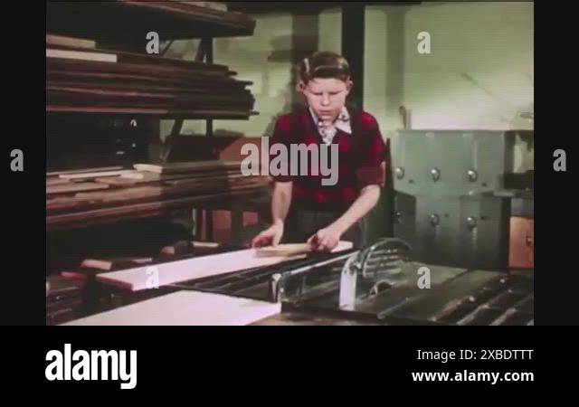 1953 - A boy demonstrates how to use a circular saw to cut a narrow ...