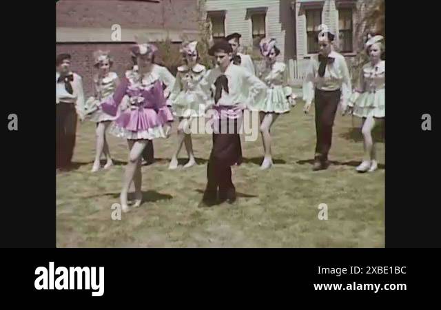 1950 - Boys and girls in glitzy costumes dance outside in North ...