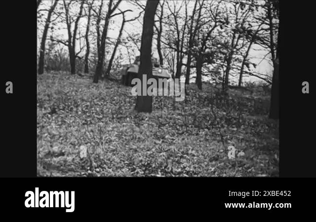 1940s - US Army tanks are driven through a forest, guns firing Stock ...