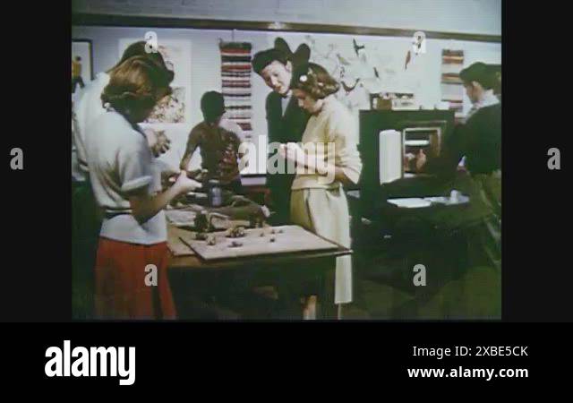 1952 - Junior high students enjoy sculpting, weaving, and painting a mural in art class Stock ...
