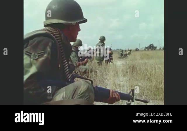 1968 - American soldiers advance on a field outside the Tan Son Nhut ...