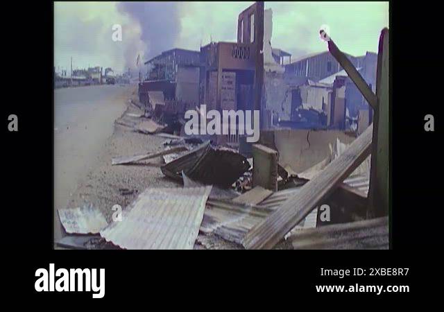1960s - Smoke rises from the wreckage of burning buildings in South ...