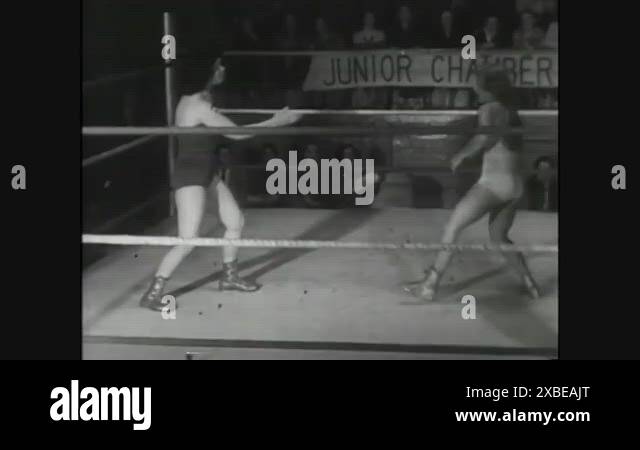 1950s - A female wrestler pins another on her stomach to the mat ...