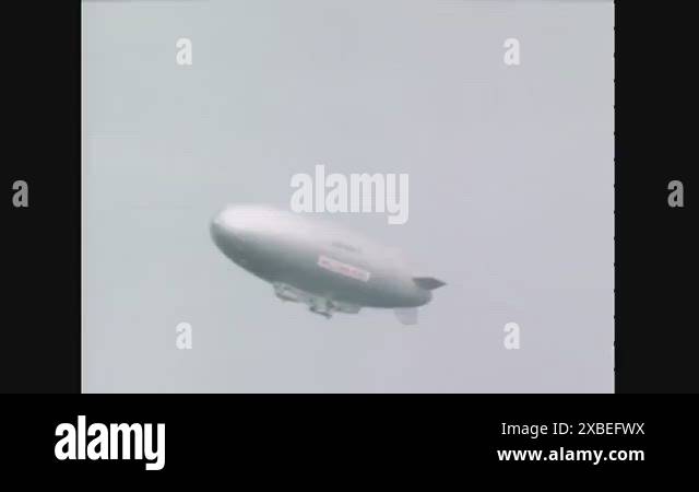 1945 - A US Navy blimp flies over an aircraft carrier with a welcome ...