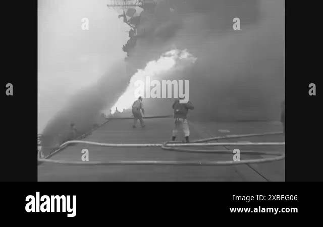 1945 - US Navy sailors are seen fighting fires on the USS Franklin ...