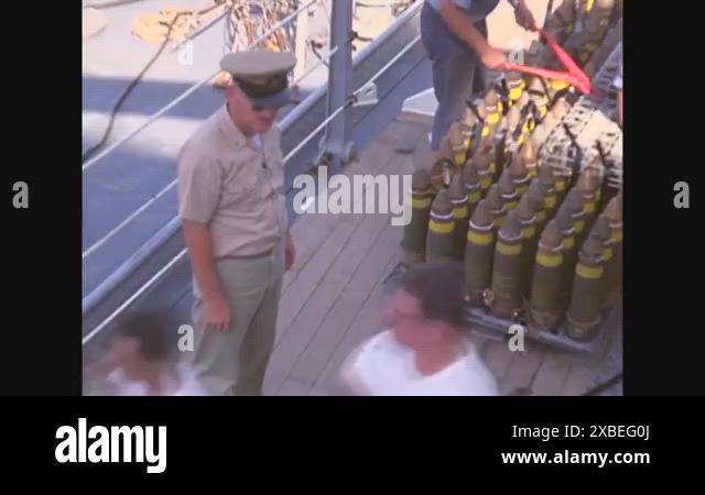 1968 - US Navy sailors unpack ammunition and pass it along the weather ...