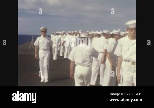 1966 - US Navy seamen break ranks after a burial at sea on the USS ...