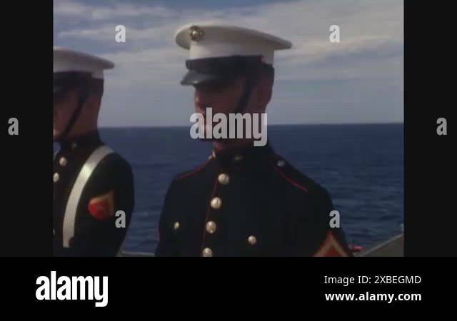1966 - US Marines and seamen stand at parade rest on the USS Oriskany ...