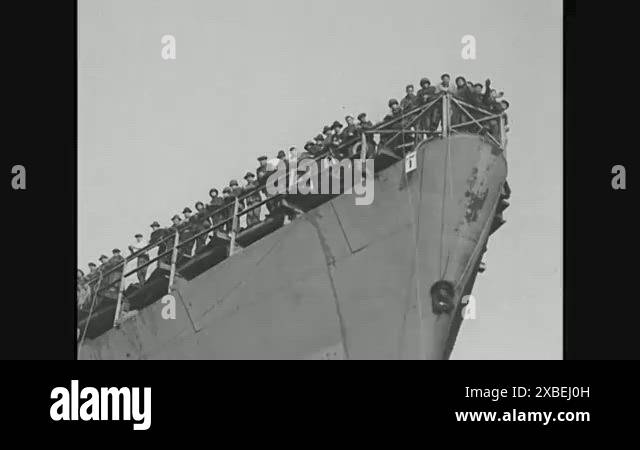 1940s - Crew members wave aboard the SS Normandie, tug boat crew ties ...