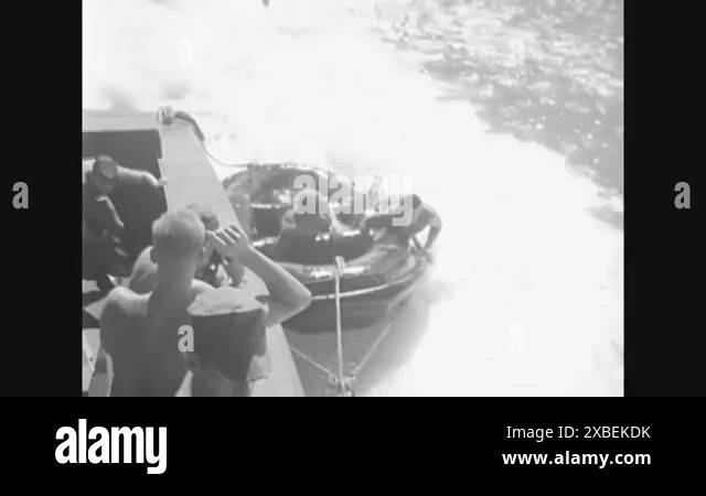 1957 - US Navy sailors on an Underwater Demolitions Team shift from a ...