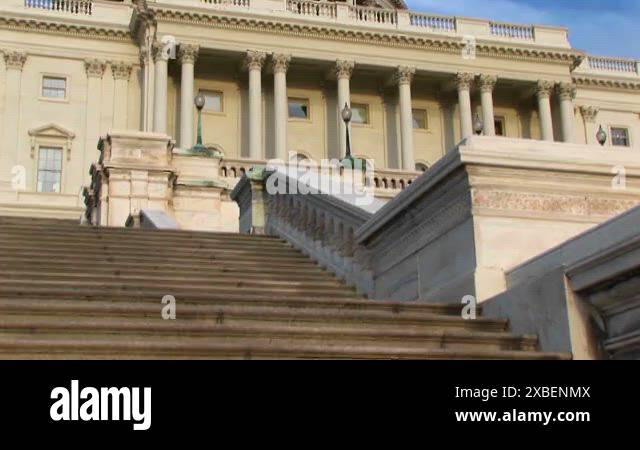 Camera pans up from steps of U.S. Capitol building in Washington, DC ...