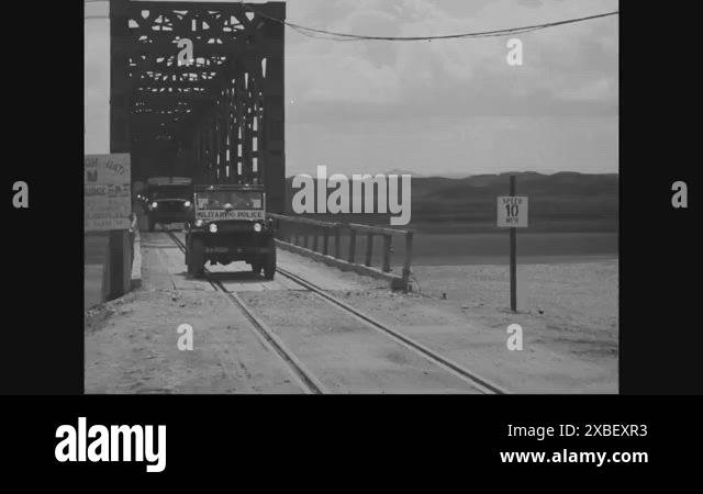 1953 - US Army ambulances, jeeps, and MP cars cross the Freedom Gate ...