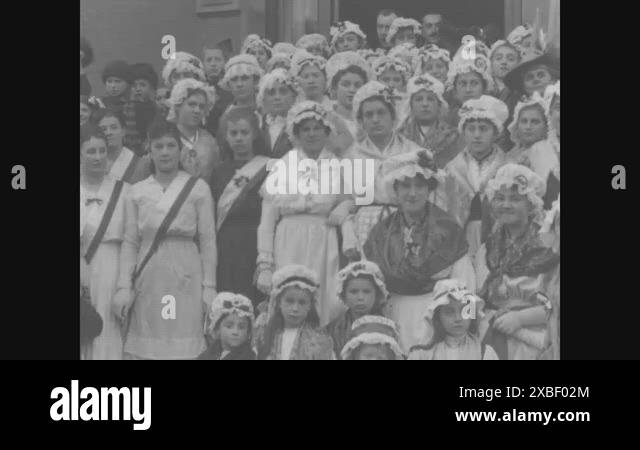 1918 - Large crowds watch troops parade through a town as they march ...