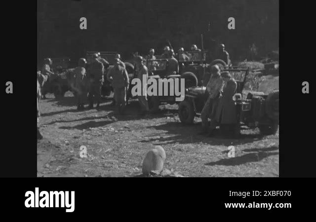 Officers look at a map and Assistant Secretary of Defense Anna ...