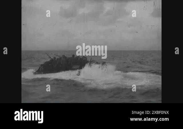 1940s, US Troops ride Higgins boats to a beach in the Pacific theatre ...