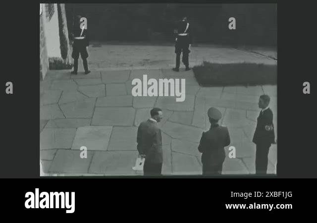 B&W, Hitler stands with officers as a guard forms and departs, color ...
