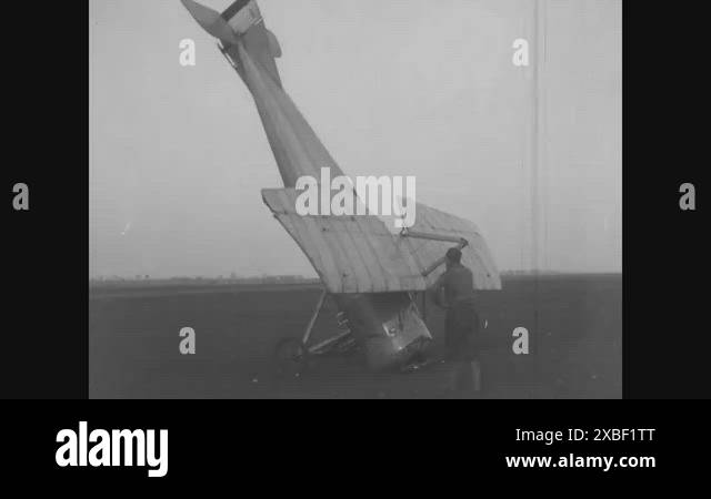 1918 - American airmen right a nose-smashed plane on an airfield, and ...