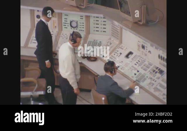 1966 - NASA personnel at the control panel, and others entering the ...