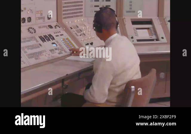 1966 - A NASA technician operates a control panel for the Apollo ...