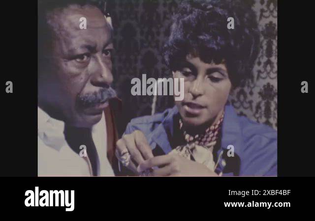 1969 - Gordon Parks and his wife are seen talking together on the set ...
