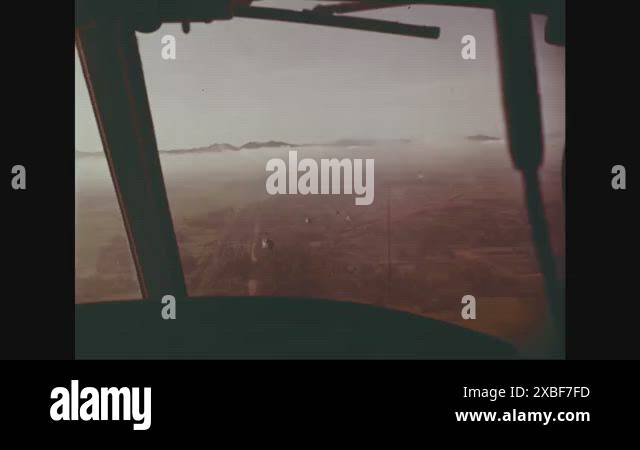1966, cockpit view of UH-1N helicopter coming in for landing, long line ...