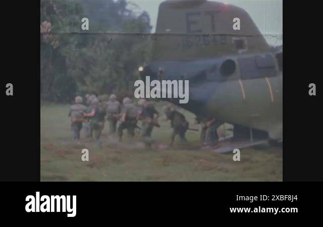 1966 - US Marines disembark from a helicopter and head for a forest in ...