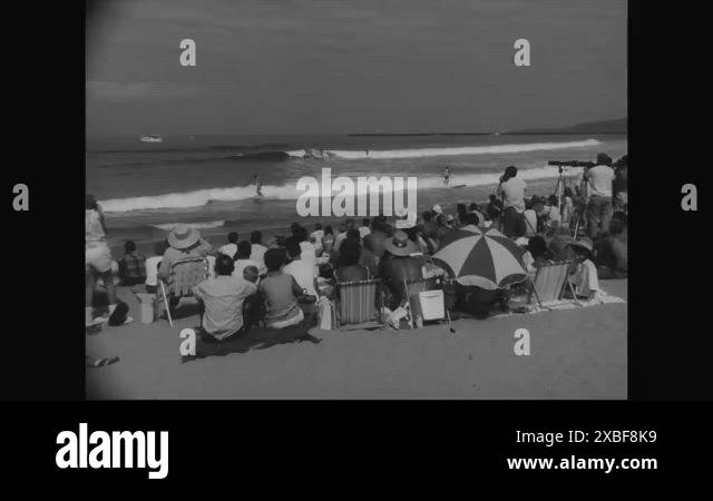 An announcer is shown with spectators including women in bikinis and ...