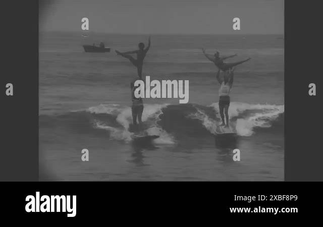 Professional surfers carry women in bikinis and a rowing event is shown ...