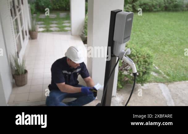 Qualified technician install home EV charging station, providing maintenance service for ...