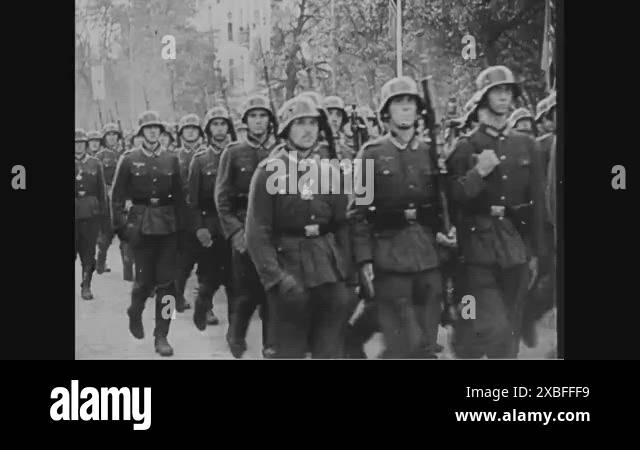 1940 - Hitler oversees a military parade which includes marching units ...