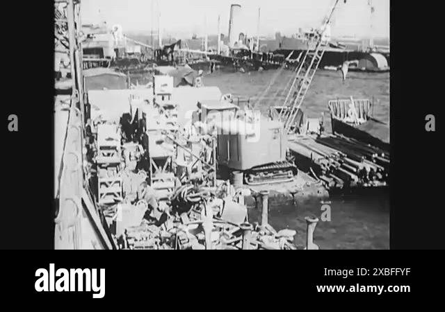 Repair barges and an artificial harbor are shown at Normandy during ...