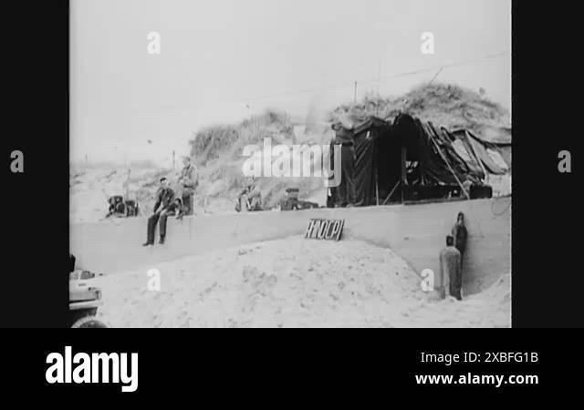 A pontoon detachment assembles a causeway used by landing craft at ...