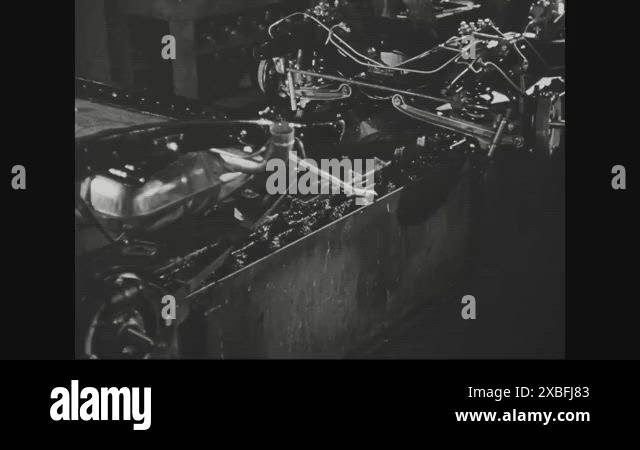 1930s - Overhead conveyers are used to put car engines onto chassis at ...