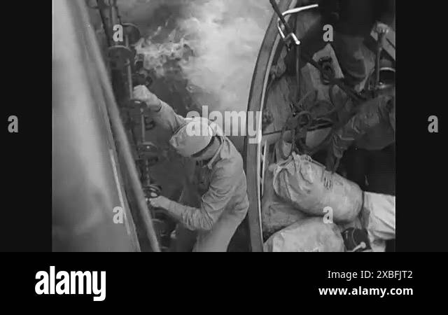 1950 - A sailor uses a Jacob's Ladder to climb from a whaleboat to the ...