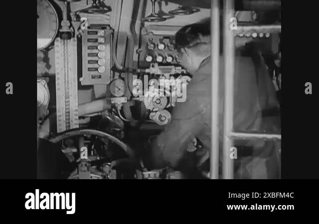 1940s - A German Naval commander looks through the periscope of a ...