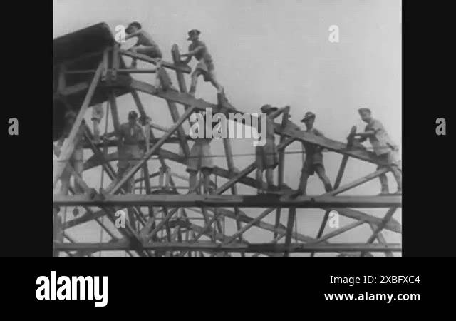 Prisoners in a World War II Japanese prison camp perform hard labor and ...