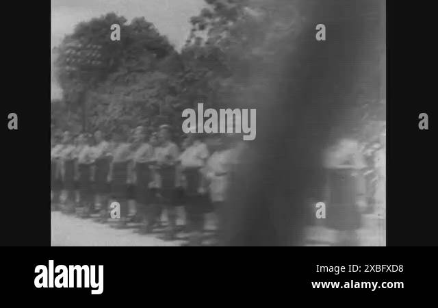 Prisoners in a World War II Japanese prison camp line up by the ...