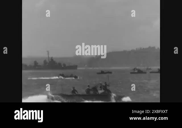 1944 - Amphibious craft, submarines, and boats approach the beach head ...