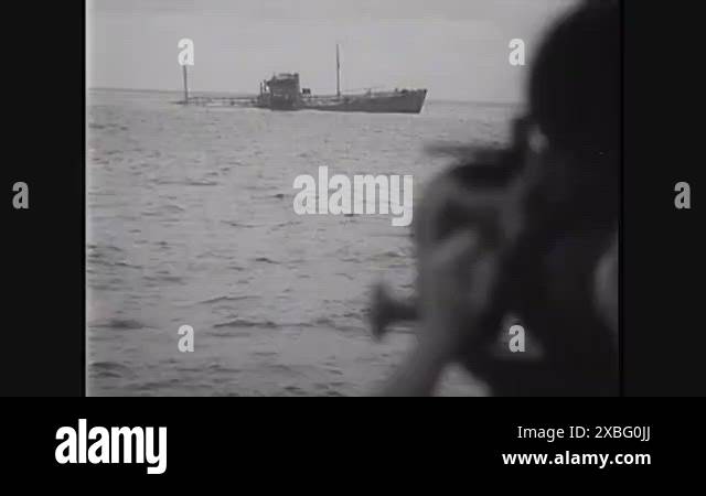 1940s - Allied survivors of a torpedo attack are pulled aboard a Japanese submarine. One ...